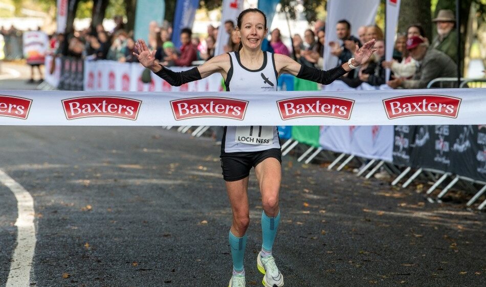 Melissah Gibson female marathon winner over finish line (2) - AW
